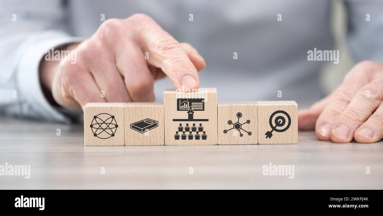 Wooden blocks with symbol of teaching concept Stock Photo - Alamy