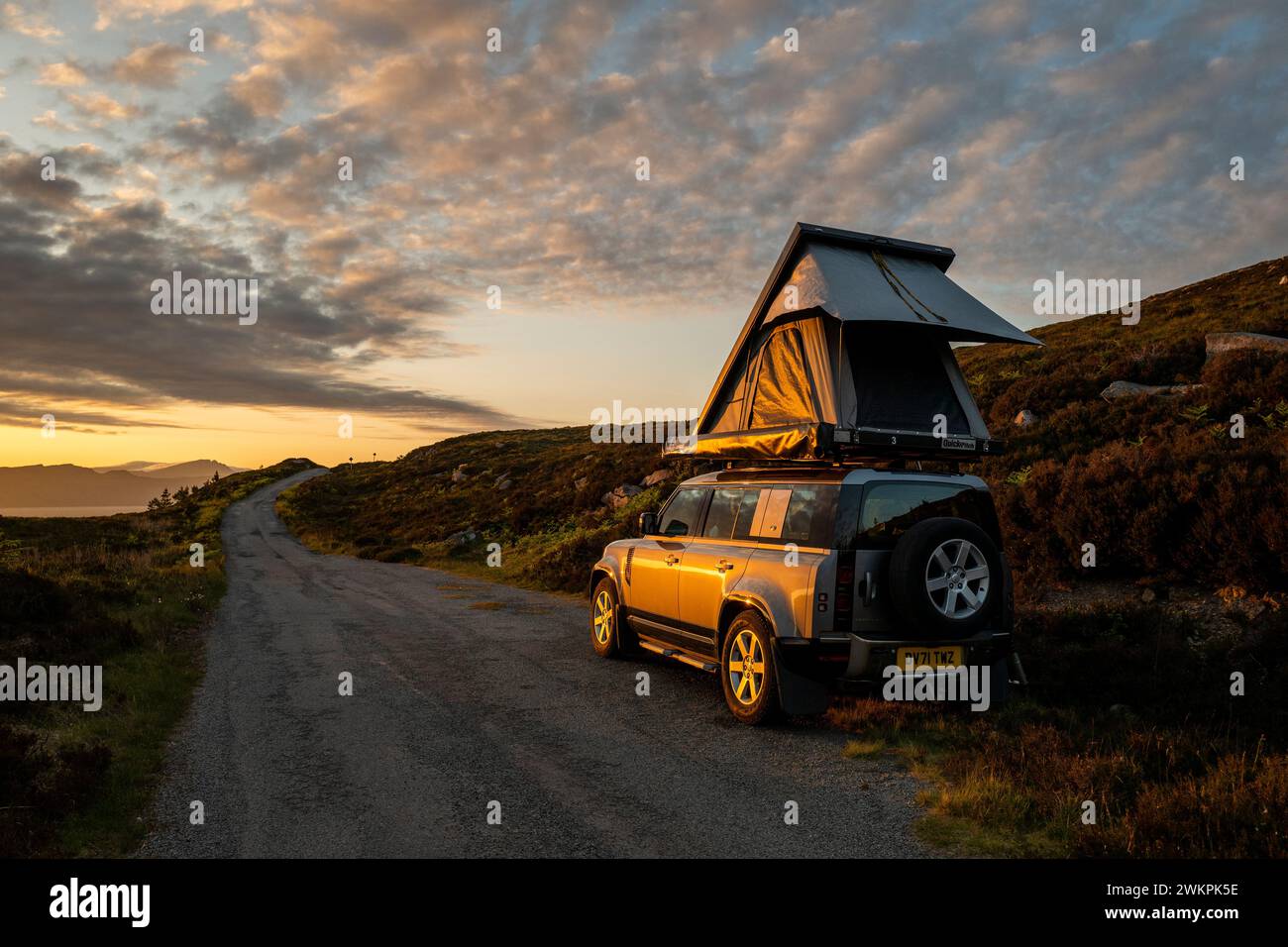A Landrover Defender 110 with a roof tent in Scotland Stock Photo - Alamy