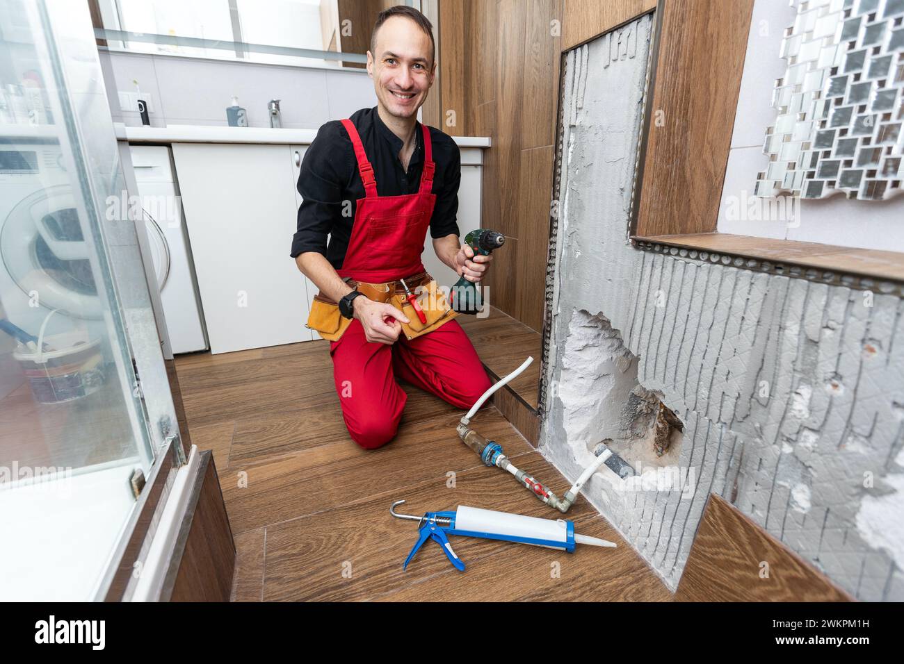 Construction worker with spirit level working on home renovations Stock ...