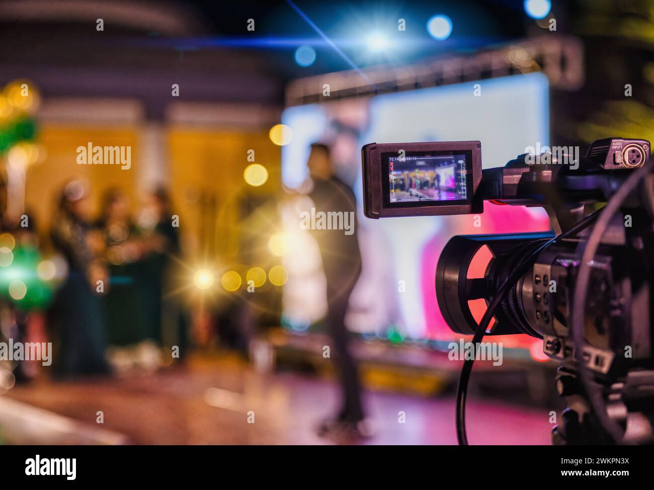 pov camcorder filming a stage with lights and lots of people ...