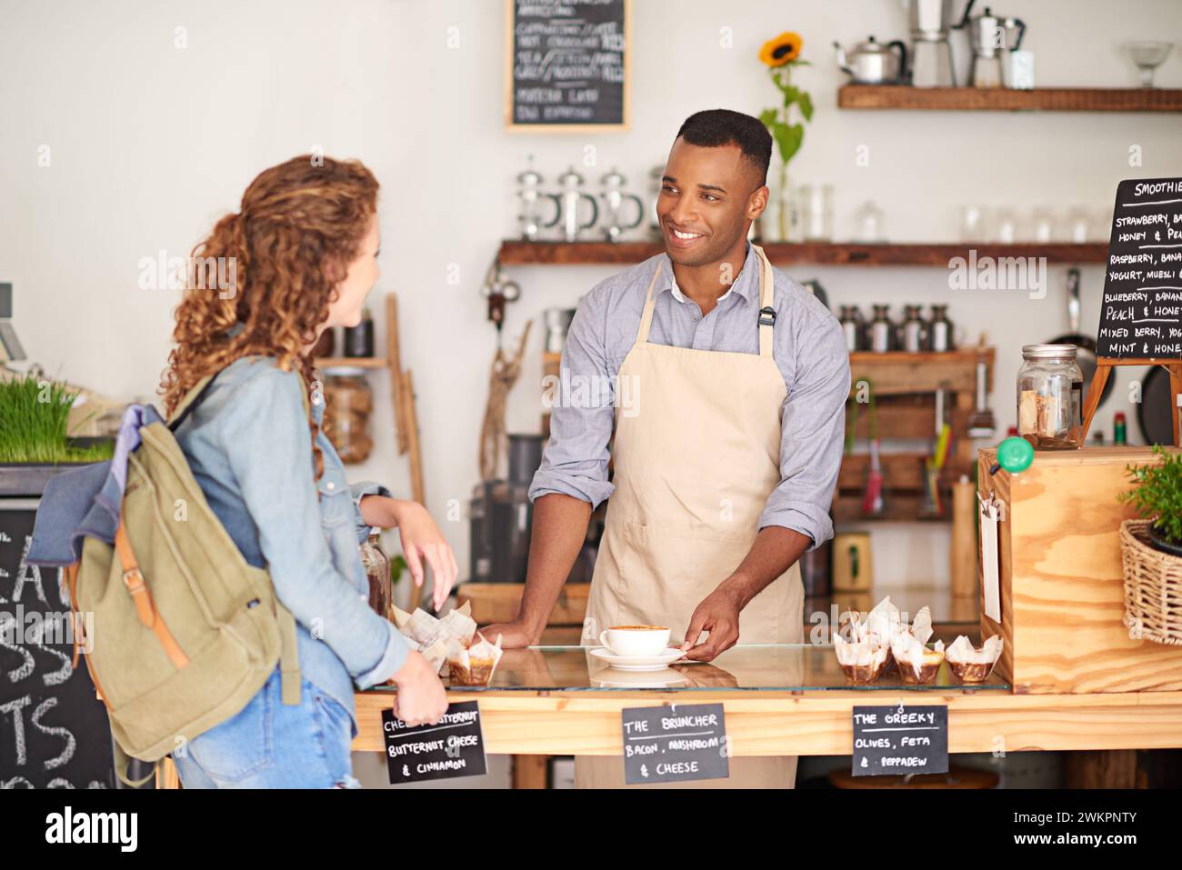 Barista, cafe and customer service with order, drink and talking with ...