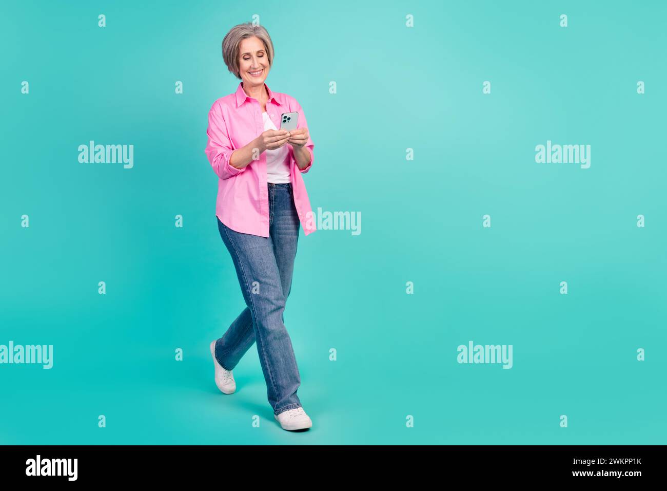 Full length photo of smart retired woman wear pink shirt read email on ...