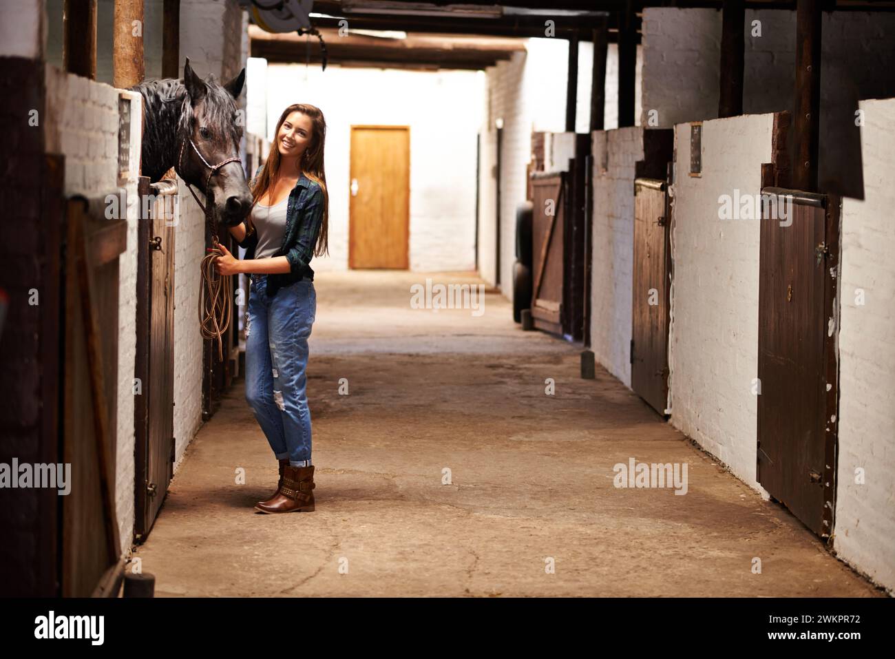 Woman, portrait and happy with horse in stable for bonding, sports ...