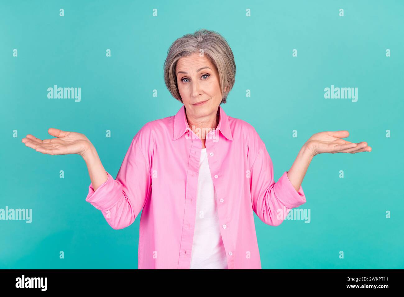 Portrait of charming retired business woman shrug shoulders dont know ...