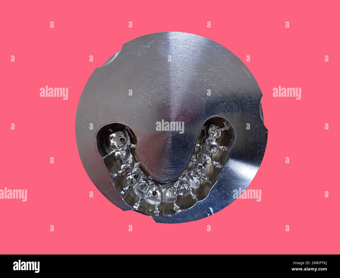 photo of the jaw, a laser cut impression in a titanium metal block, a ...