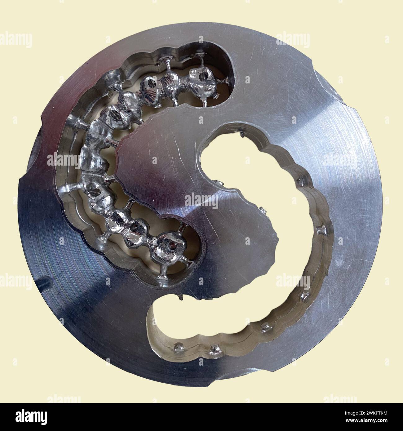 photo of the jaw, a laser cut impression in a titanium metal block, a ...