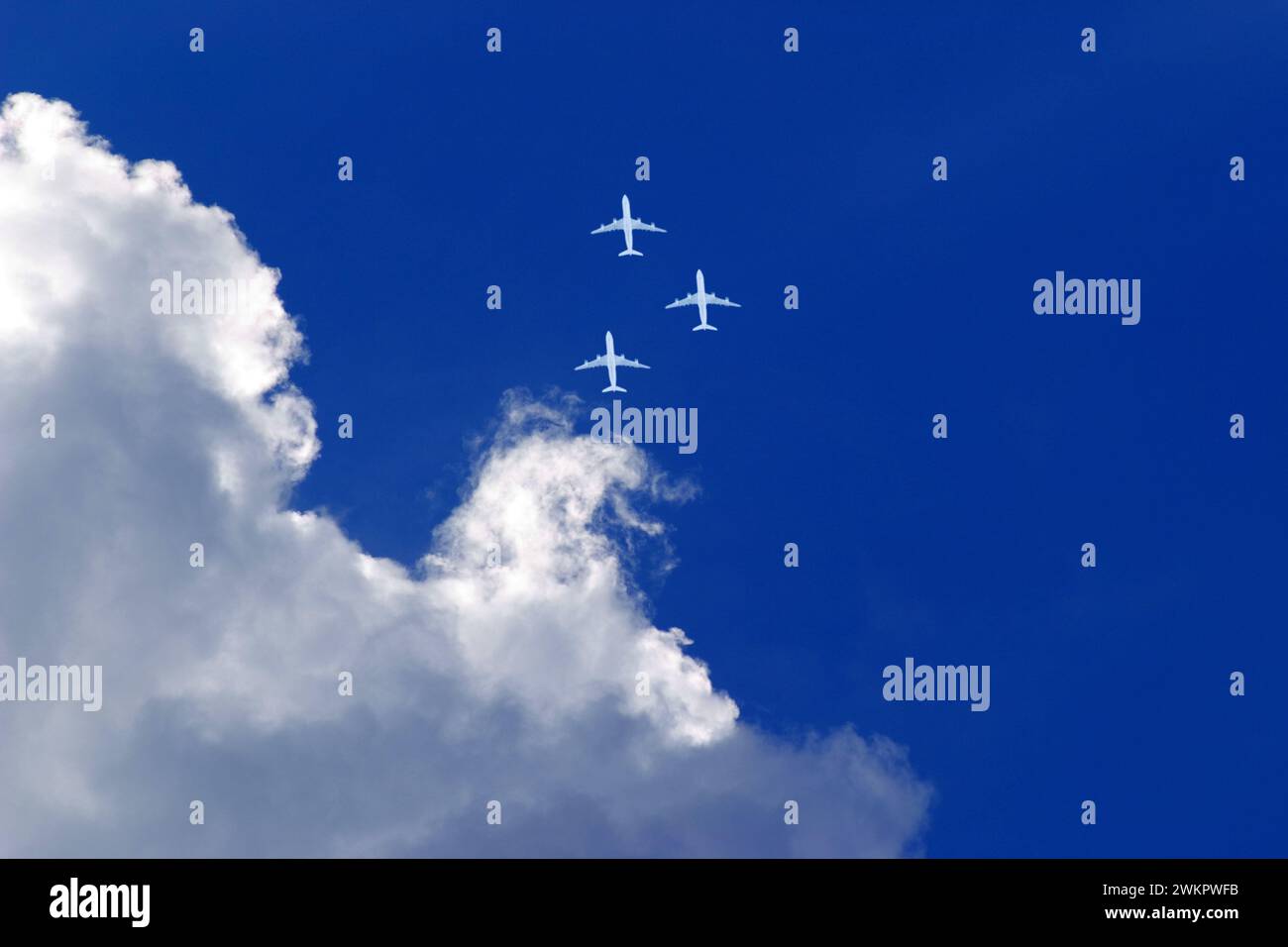 three white passenger airplanes in blue sky Stock Photo - Alamy