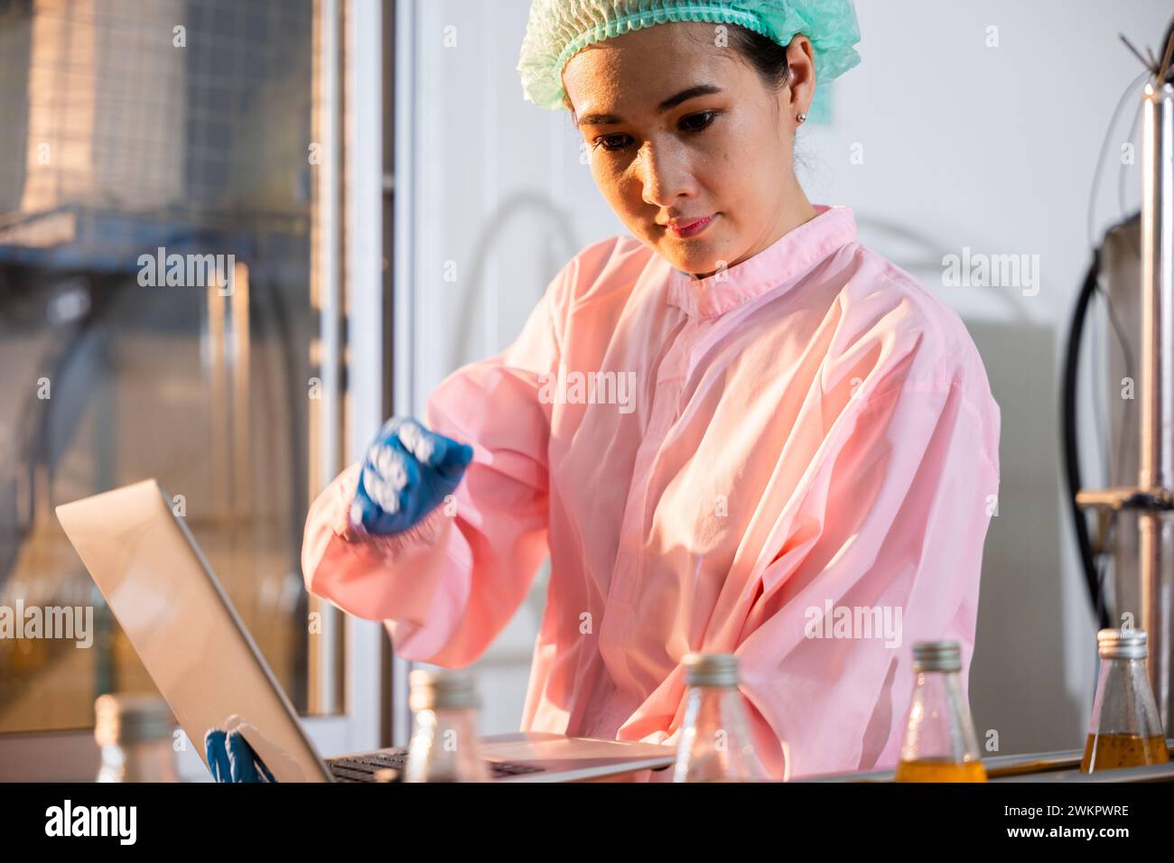 Quality inspector a woman carefully examines beverage bottles on a ...