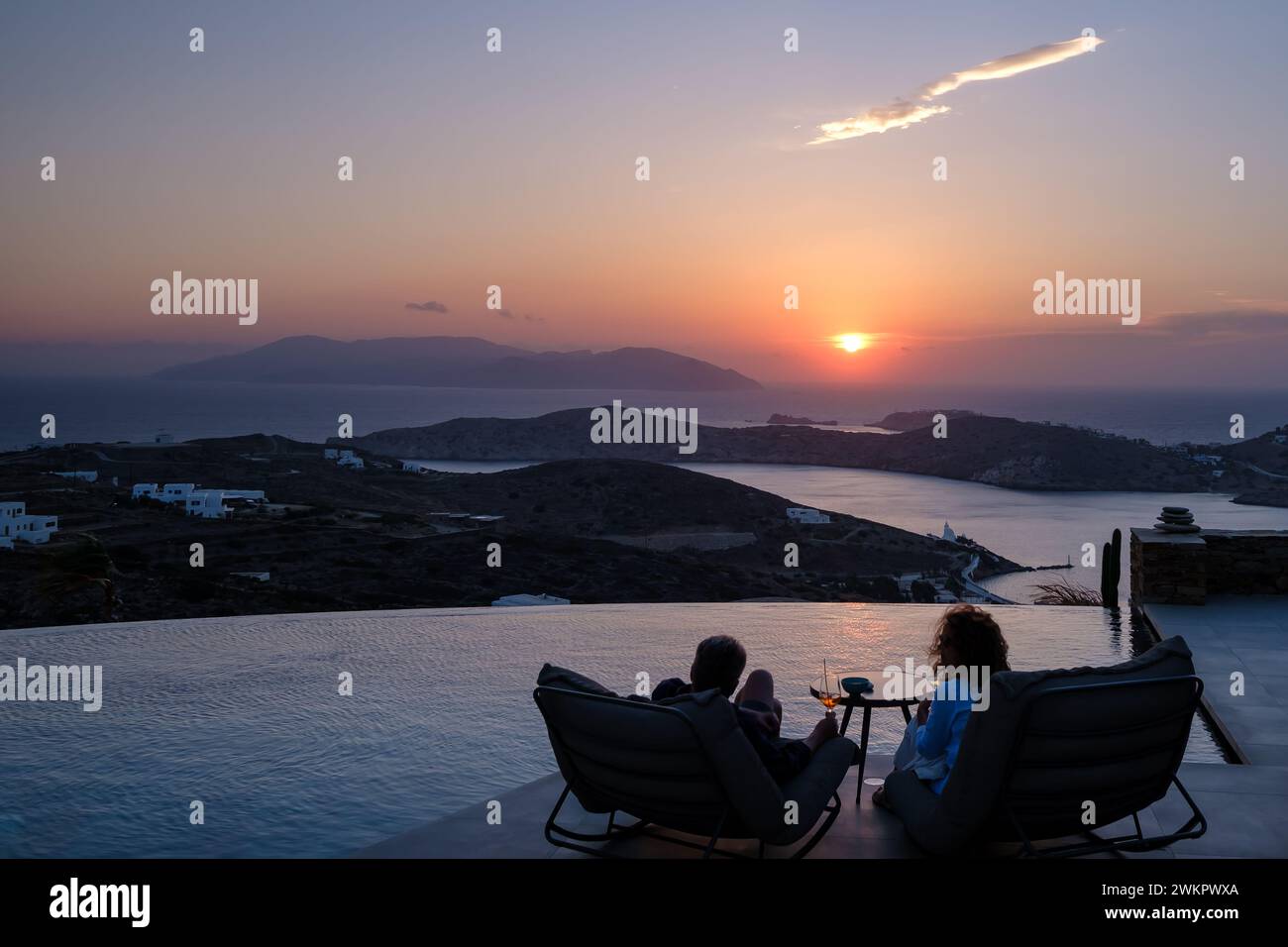 Ios, Greece - September 17, 2023 : View of a couple sitting in front of ...