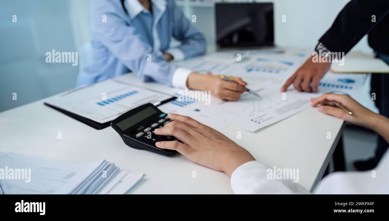 Businesswoman using a calculator to calculate numbers on a company's ...
