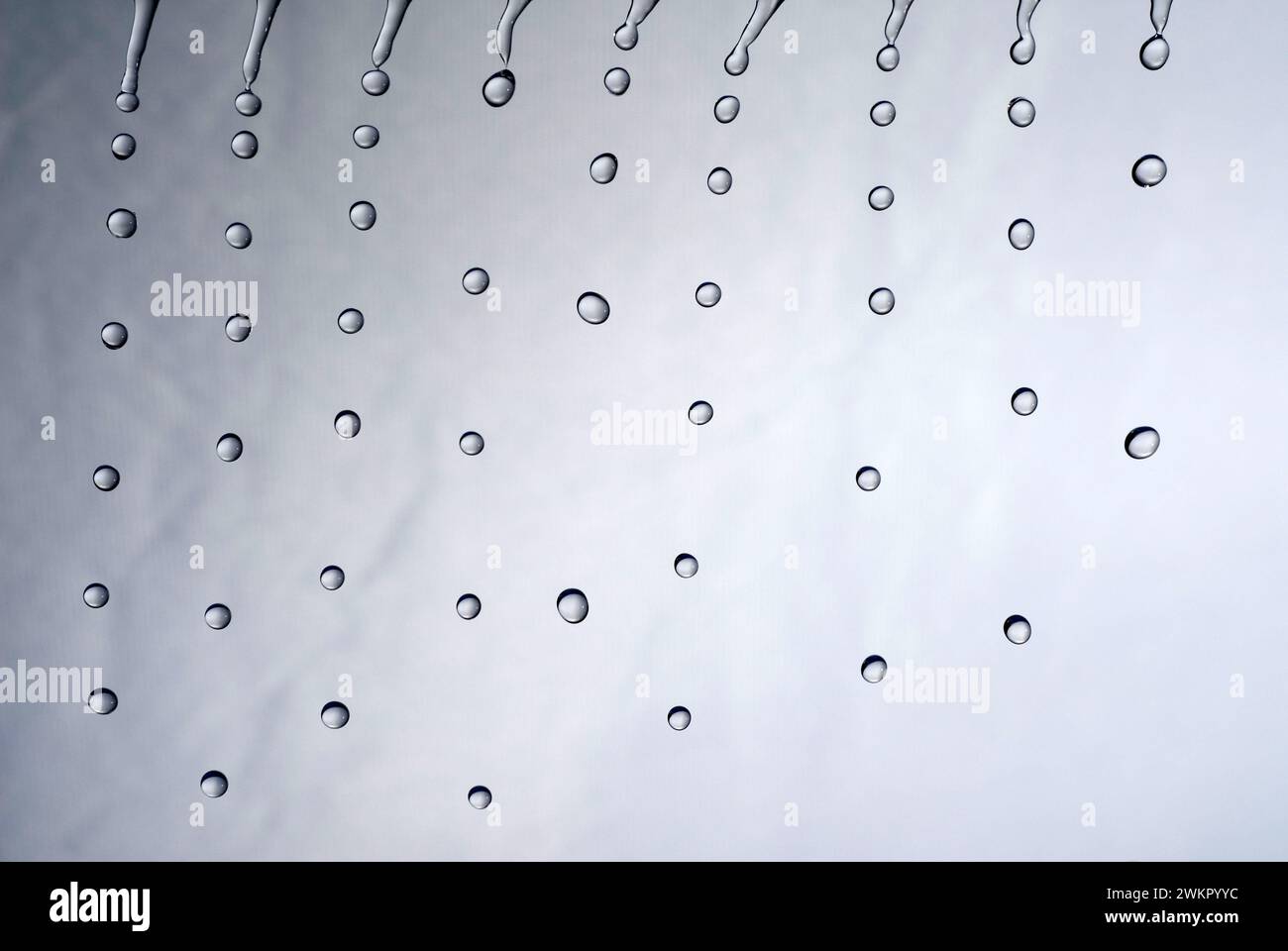 many water drops falling looking like rain or a shower in the bathroom ...