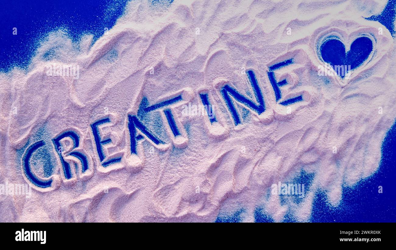 Word creatine written on strawberry creatine powder with a heart ...