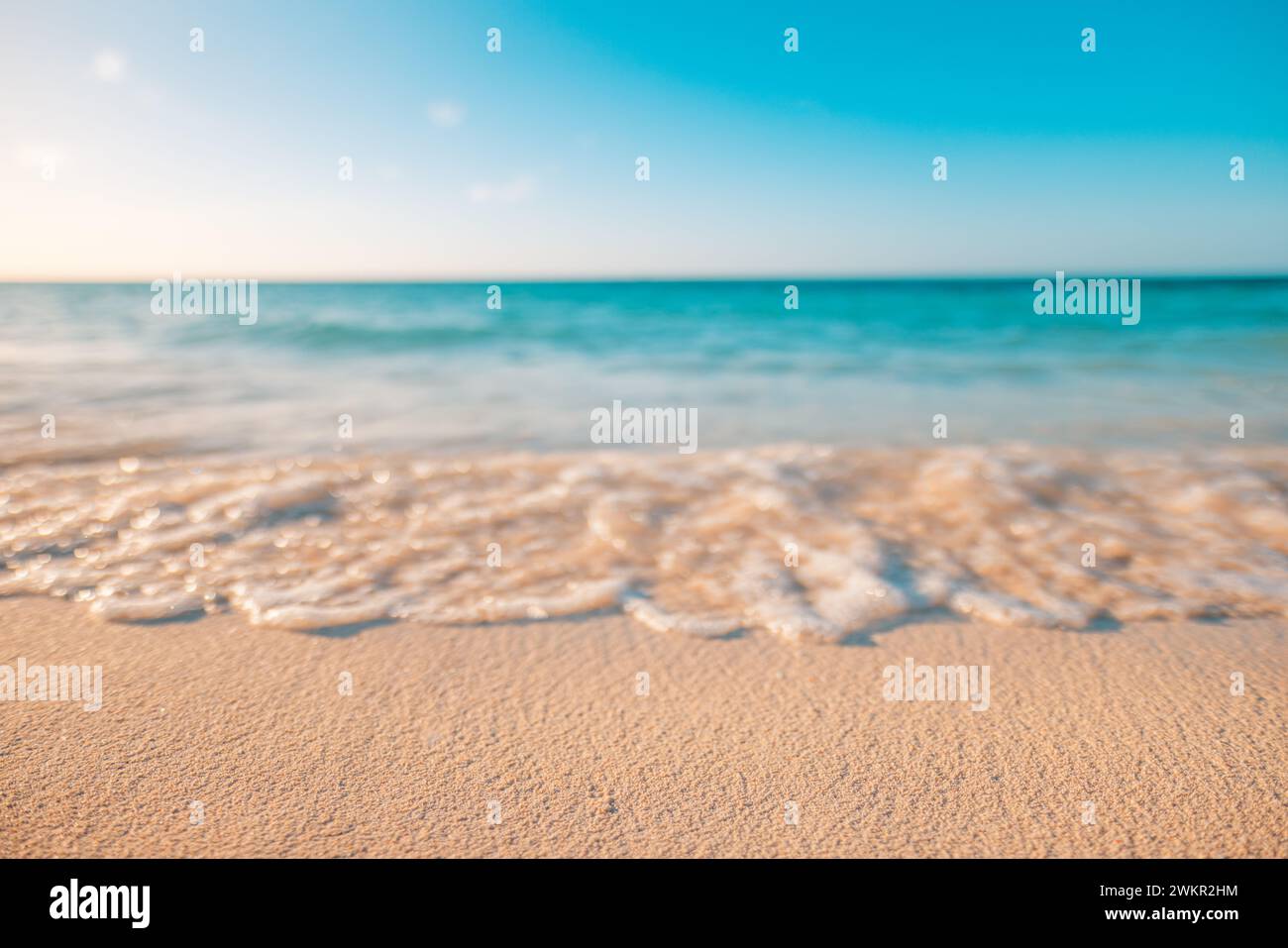 Fantastic closeup view of calm sea water waves with orange sunrise ...