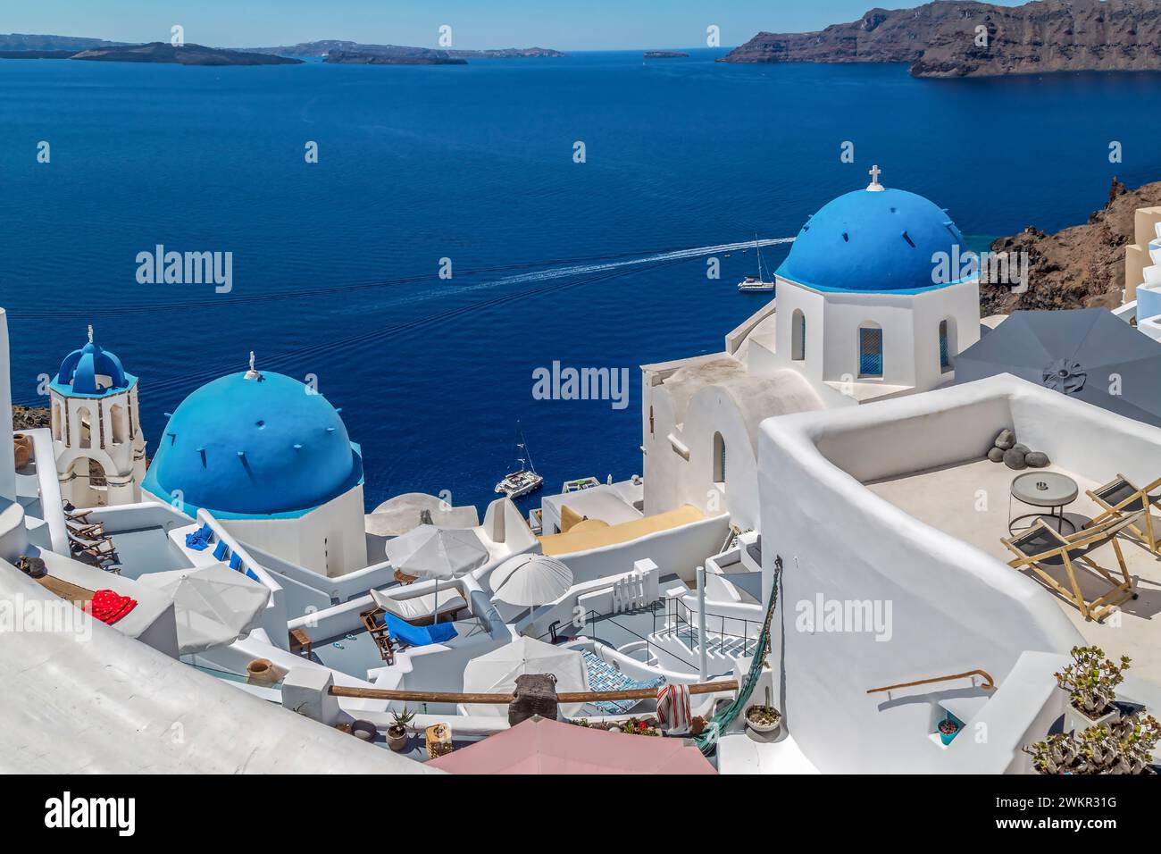 Typical white and blue architecture with domes and churches of Oia ...