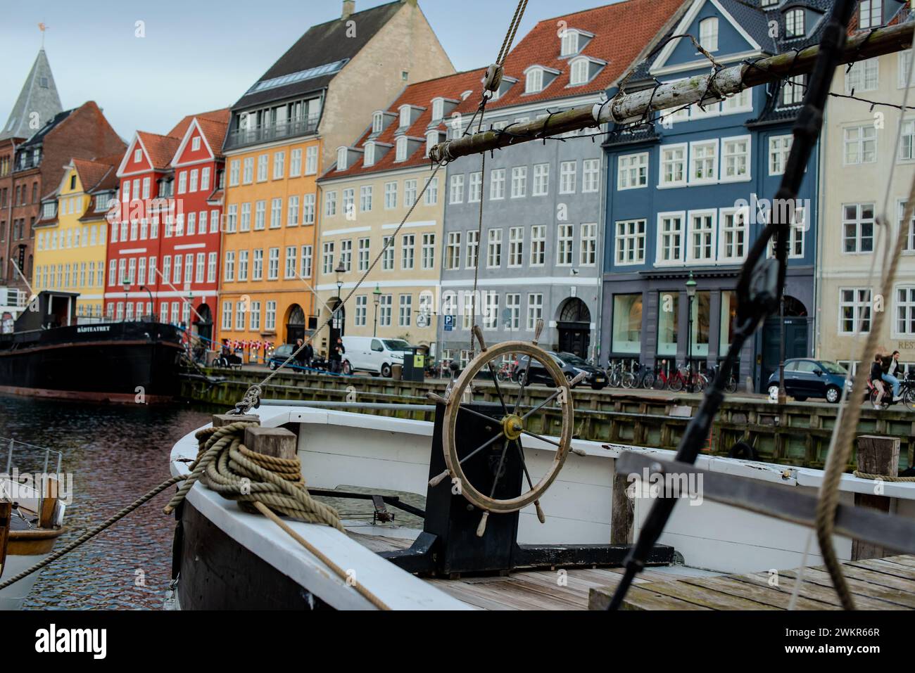 A scenic river view of vibrant buildings and boats in Copenhagen ...