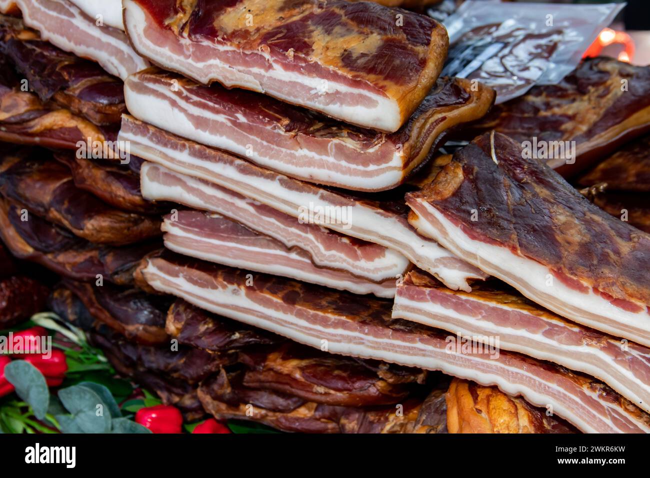 Exposed bacon and dried meat domestic products presented for sale on a ...