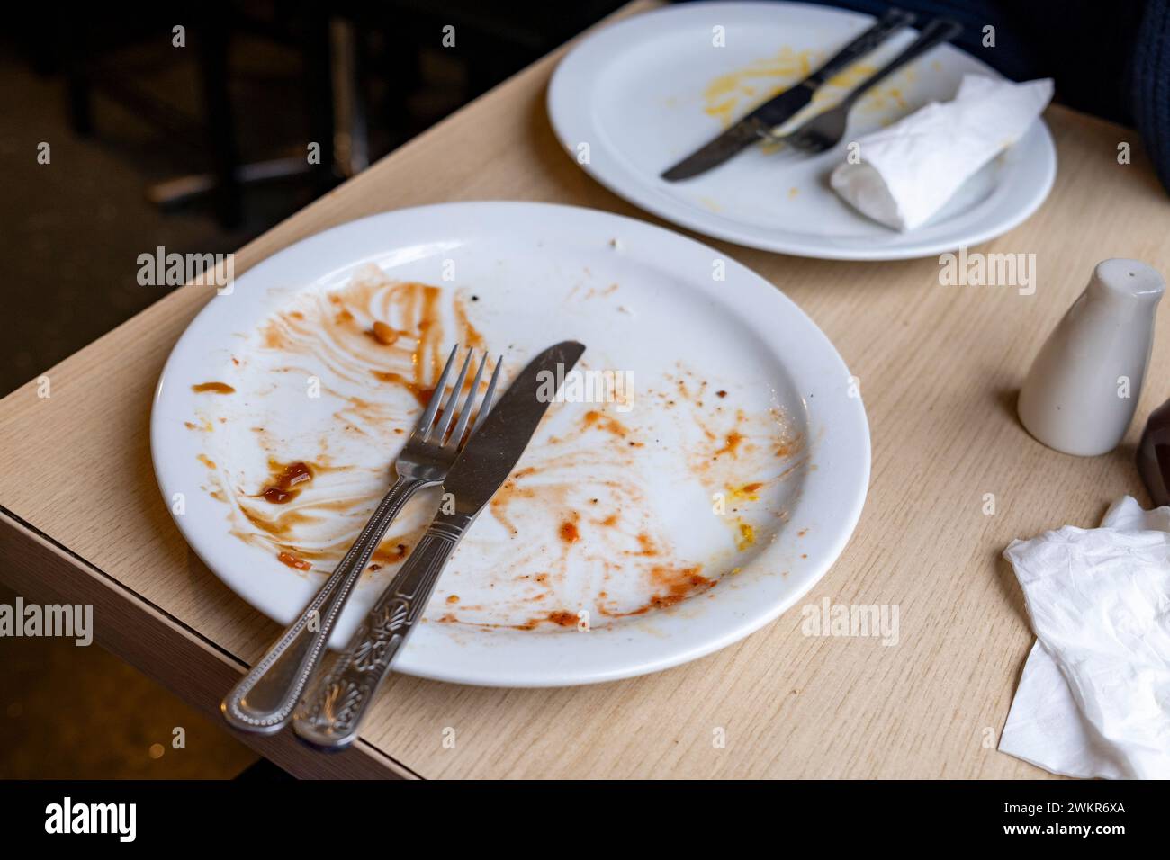 Empty plate following a full English breakfast in a greasy spoon cafe ...