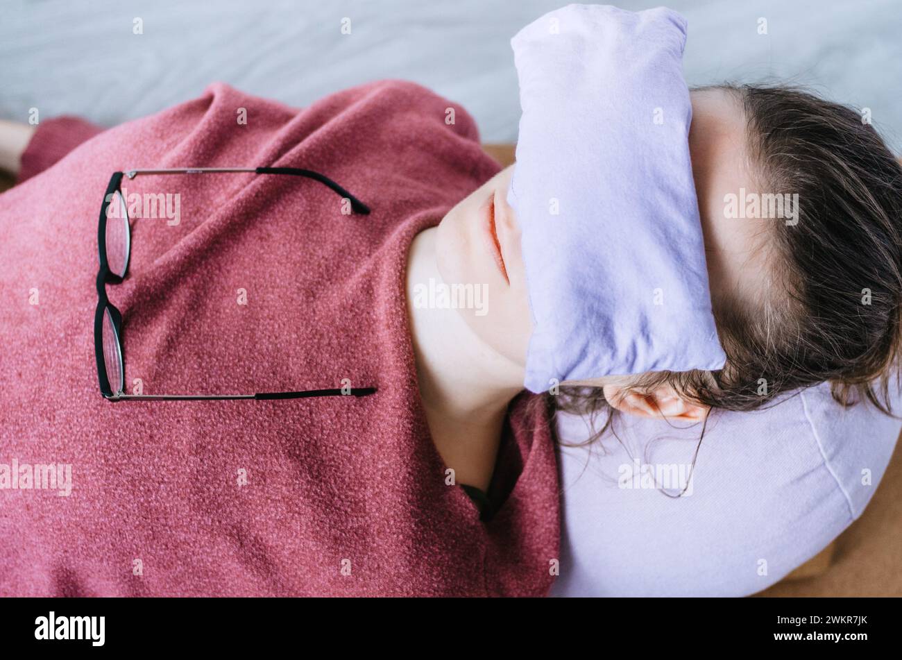 Eye strain self care break: woman with lavender eye pillow Stock Photo ...