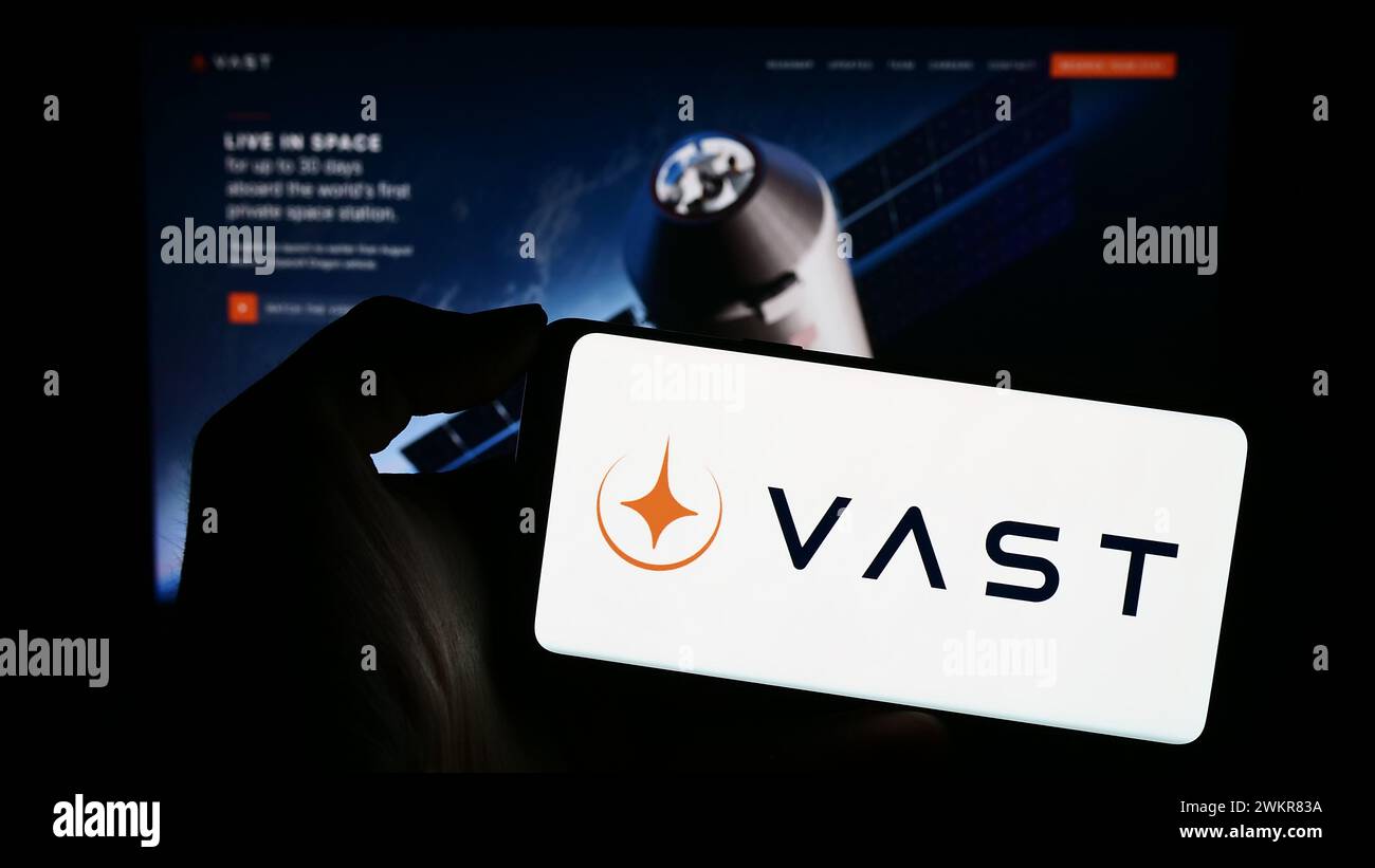 Person holding mobile phone with logo of American aerospace company ...