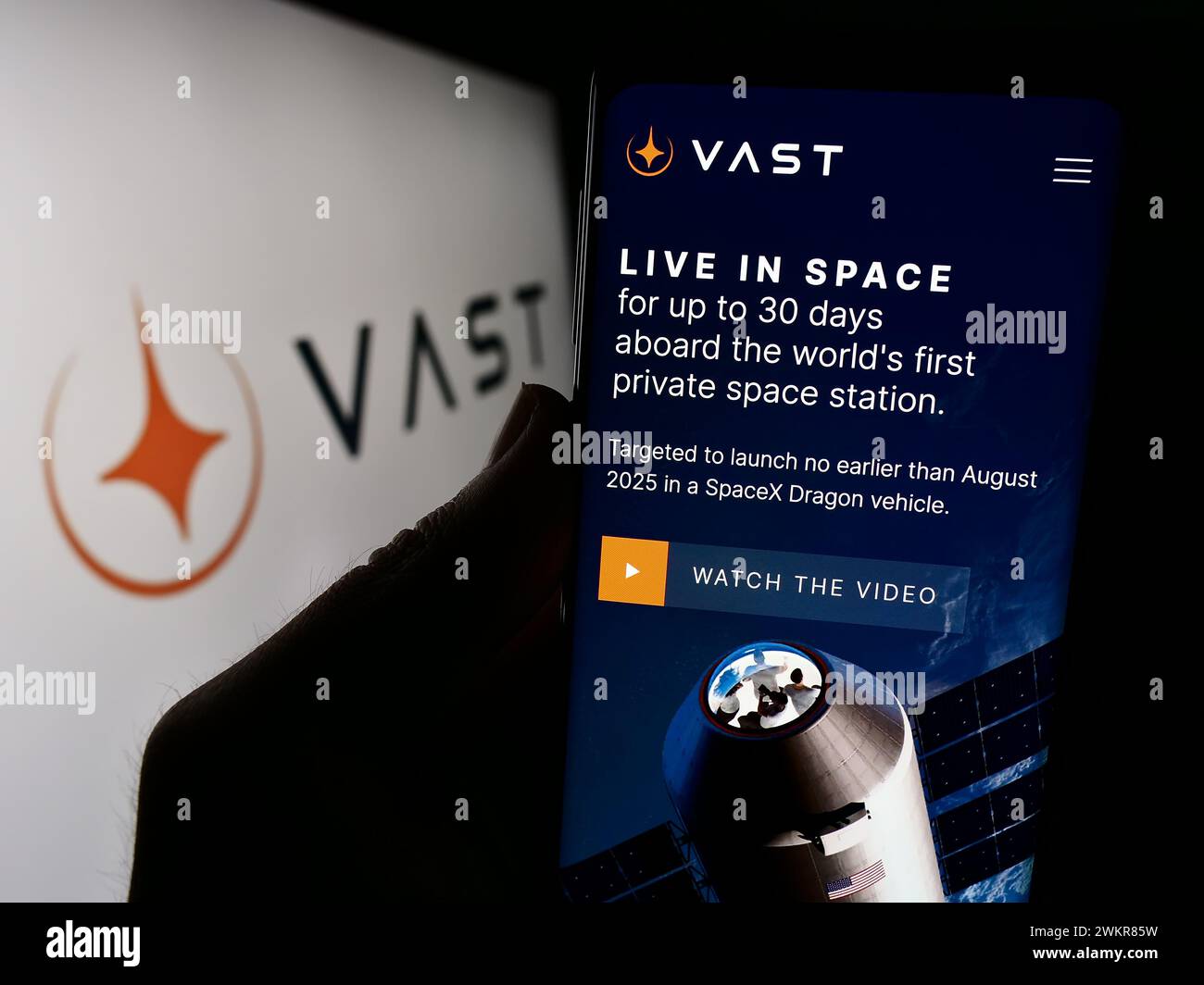 Person holding cellphone with webpage of US aerospace company VAST ...