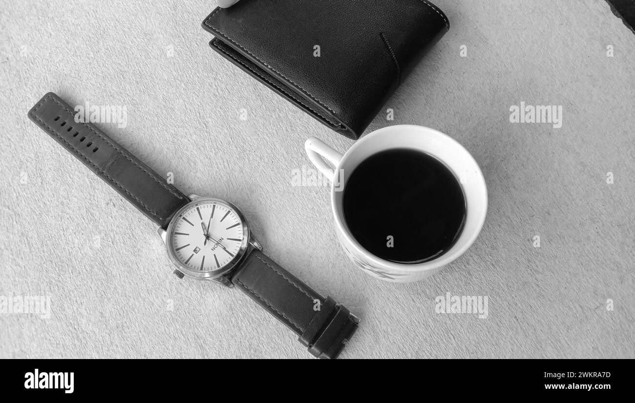 Photo of leather wallet, black coffee and watch on white background ...