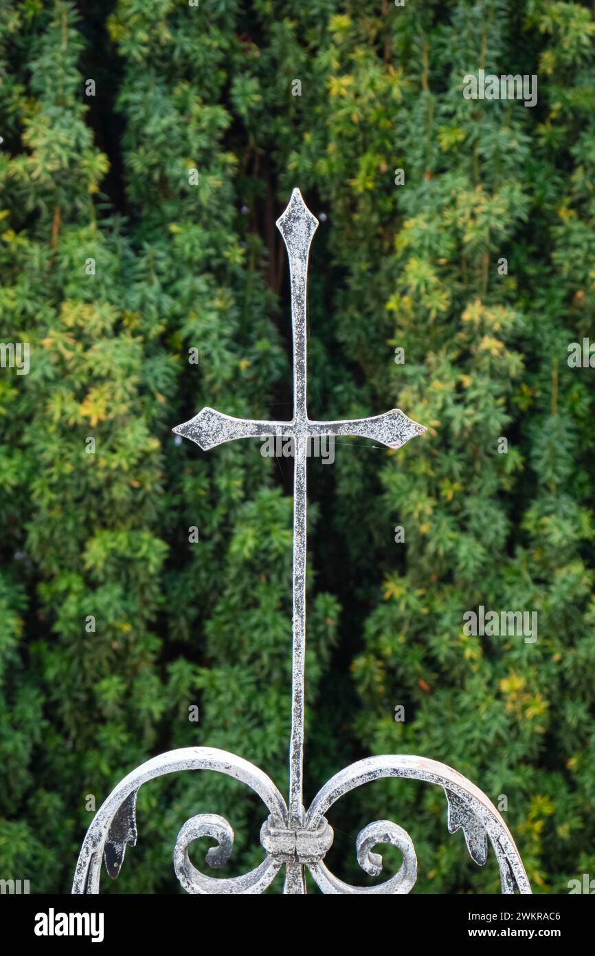 Forged iron decorative cross in a European cemetery. Close up shot ...