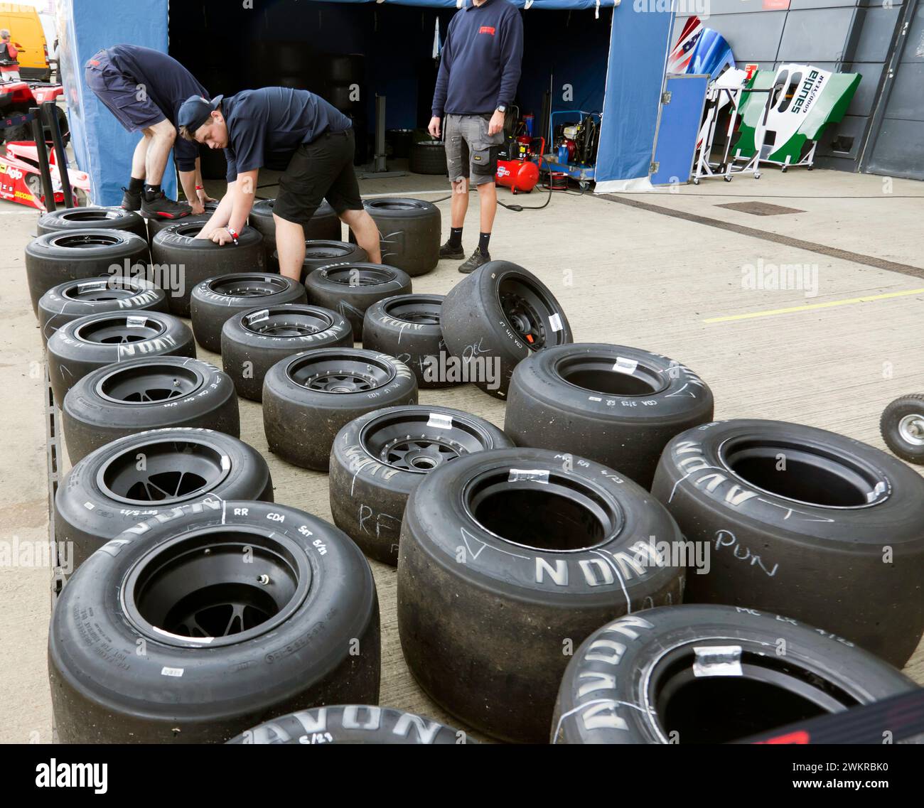 Pit Crew organising and prepping racing tyres for teams at the 2023 Silverstone Festival Stock ...