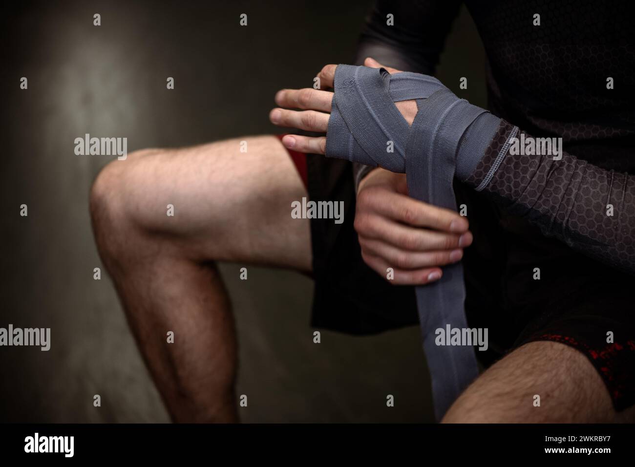 Boxer securing handwraps around wrists before sparring match Stock ...