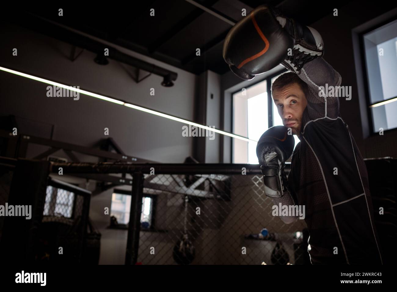Boxer throwing powerful left hook during shadowboxing in gym Stock ...