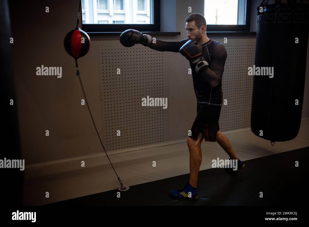 Focused boxer improving punch speed with floor to ceiling bag Stock ...