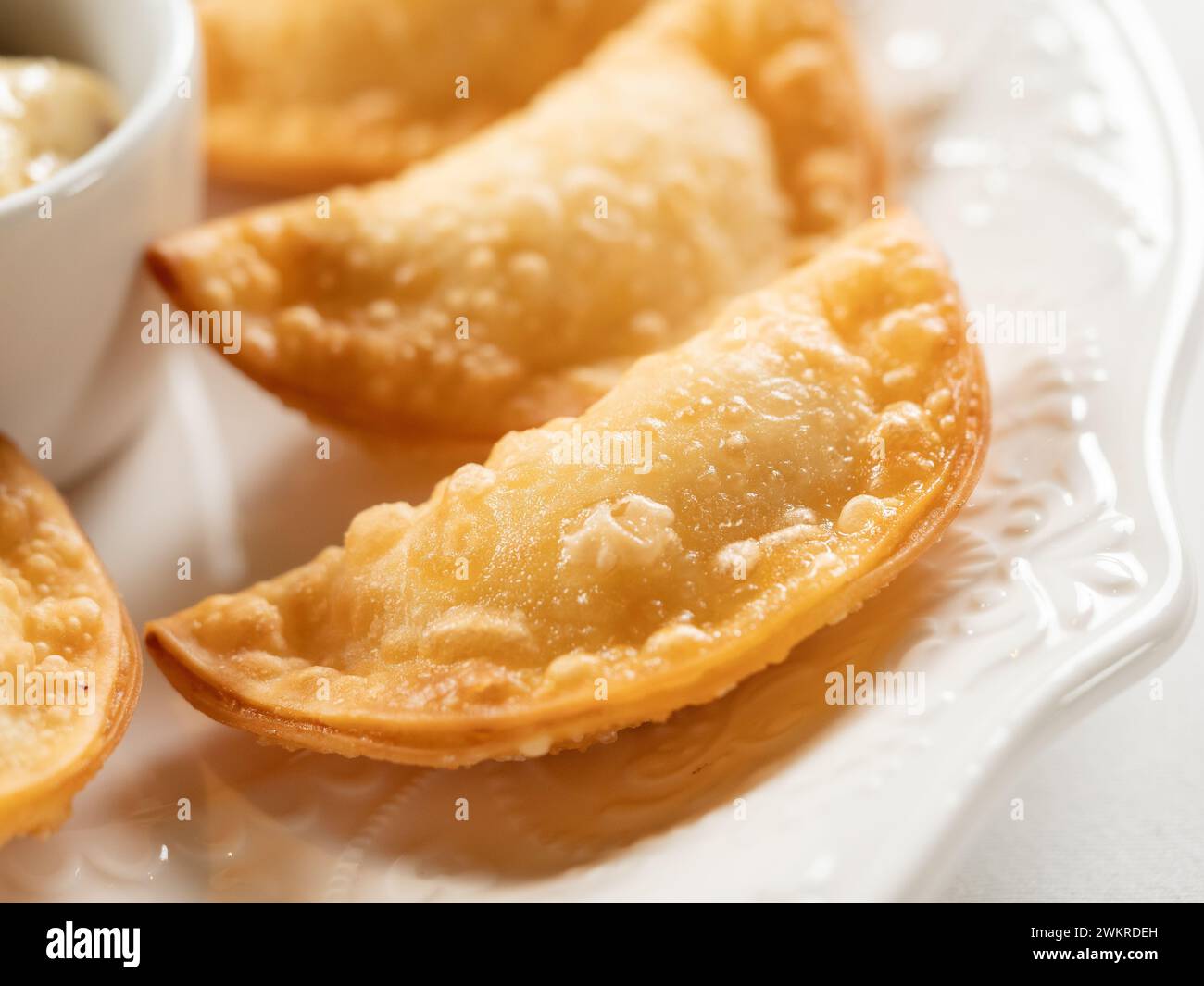 Hot Appetizers with Mini Chebureki and sauces Isolated on white table ...