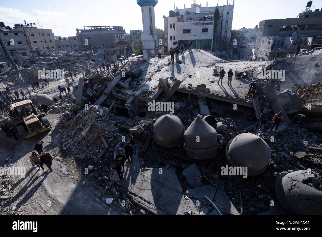 Palestinians look at the destruction after an Israeli strike on ...