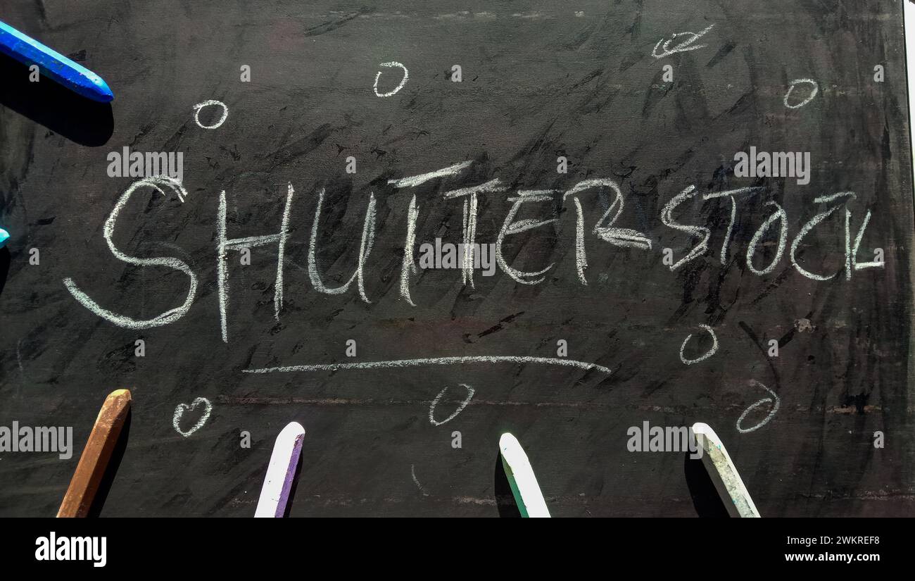The text "SHUTTERSTOCK" on a black background is written in crayons ...