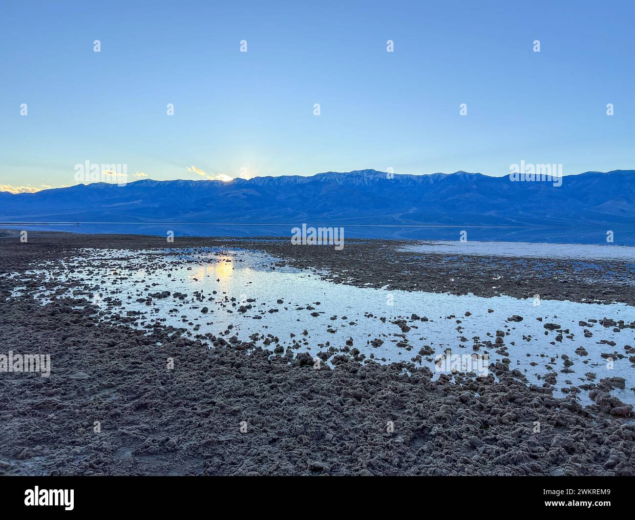 A scenic view of Lake Manly (Badwater Basin) in Death Valley at sunset ...