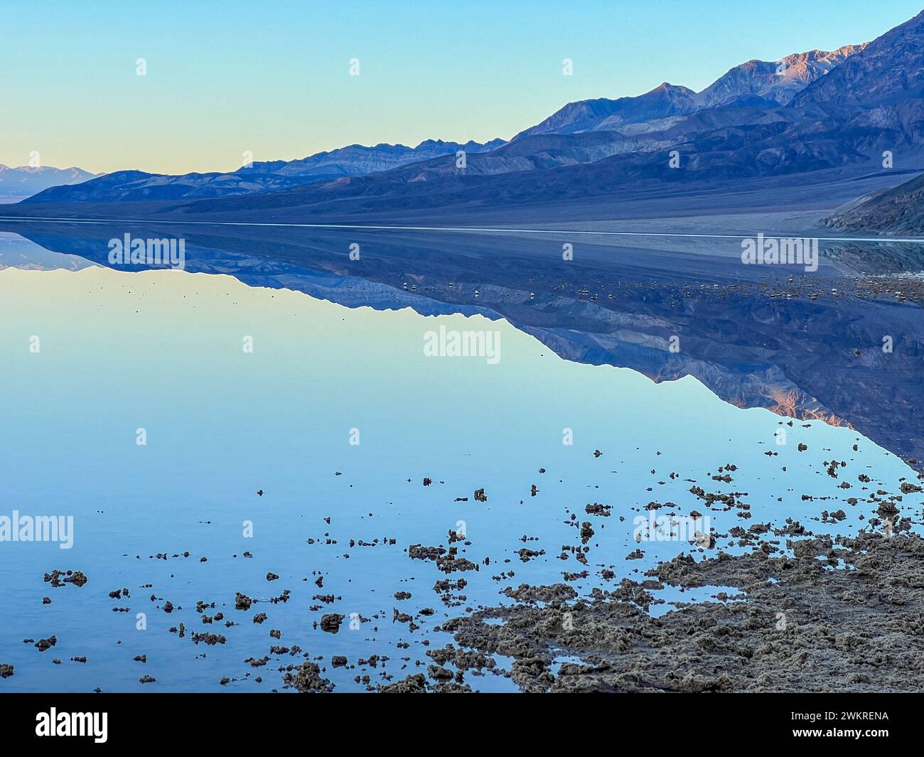 A scenic view of Lake Manly (Badwater Basin) in Death Valley at sunset ...