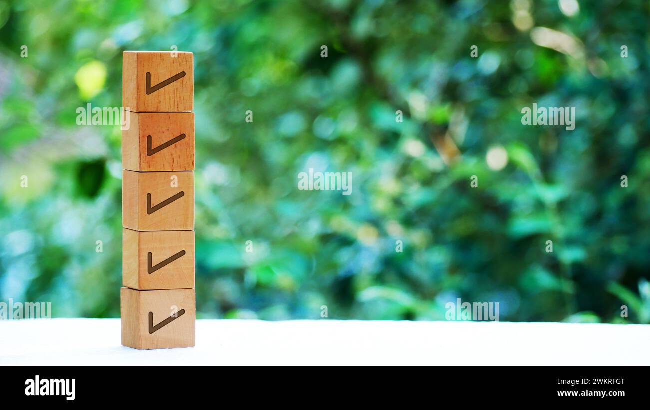 Checklist box with checkmarks engraved on wooden block Stock Photo - Alamy