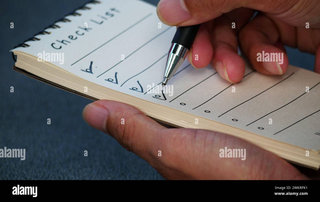 A businessman preparing checklist at office desk Stock Photo - Alamy
