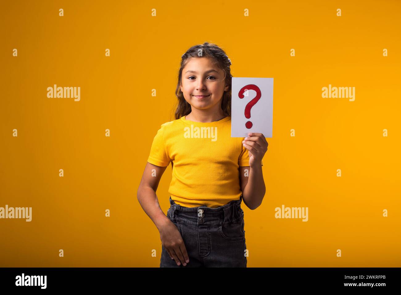 A portrait of smiling kid girl holding question mark card. Children ...