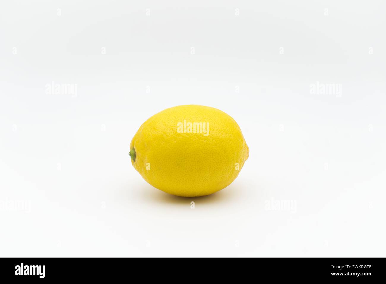 A fresh yellow lemon on a white background Stock Photo - Alamy