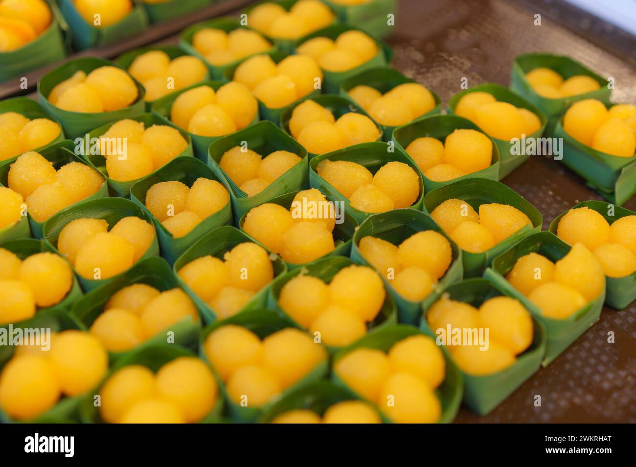 Kanom Thong Yod, a traditional Thai dessert made from egg yolks and sugar syrup, served in ...