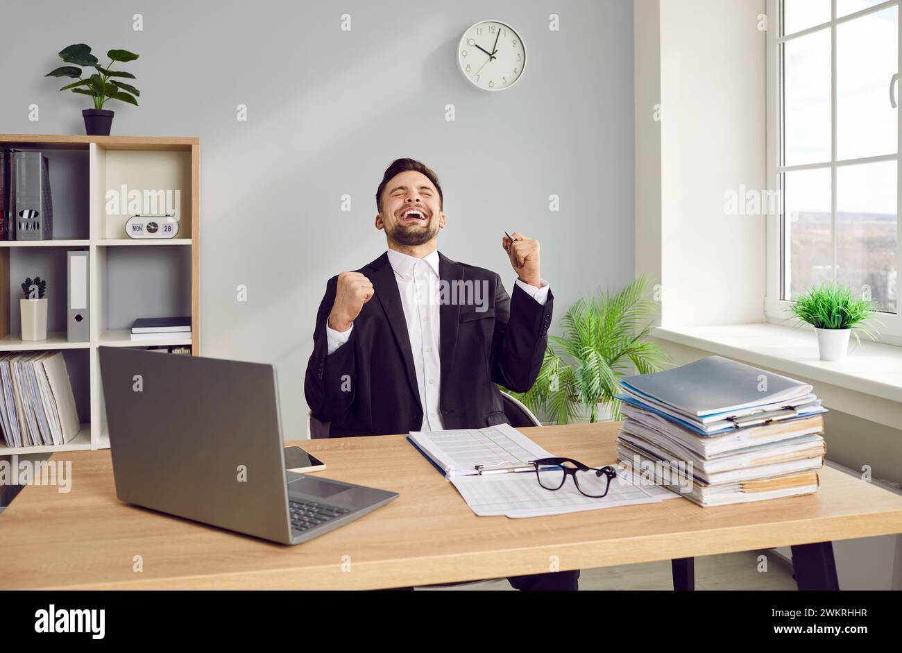 Business man sitting in the office making yes gesture with hands in ...