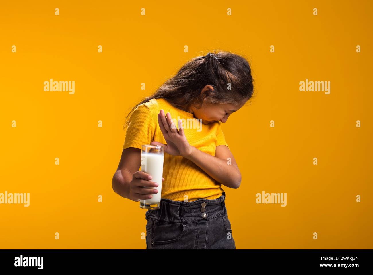 Portrait of kid girl with dairy allergy showing stop gesture front ...