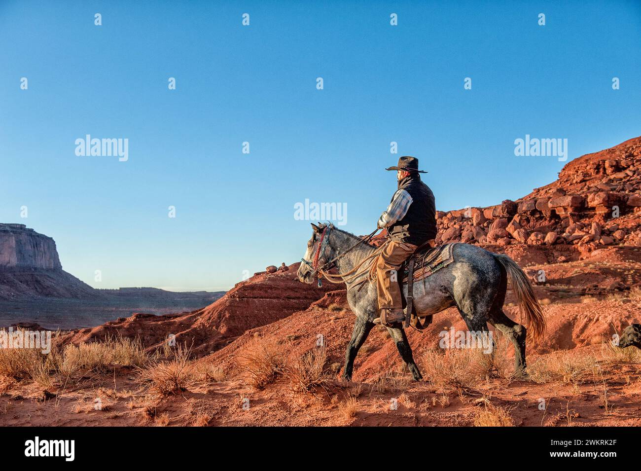 Native cowboy in Monument Valley, which is famous for its iconic buttes ...
