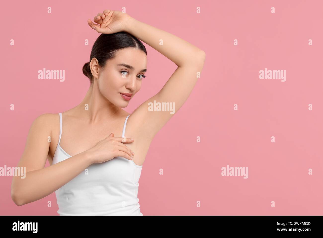 Beautiful woman showing armpit with smooth clean skin on pink ...