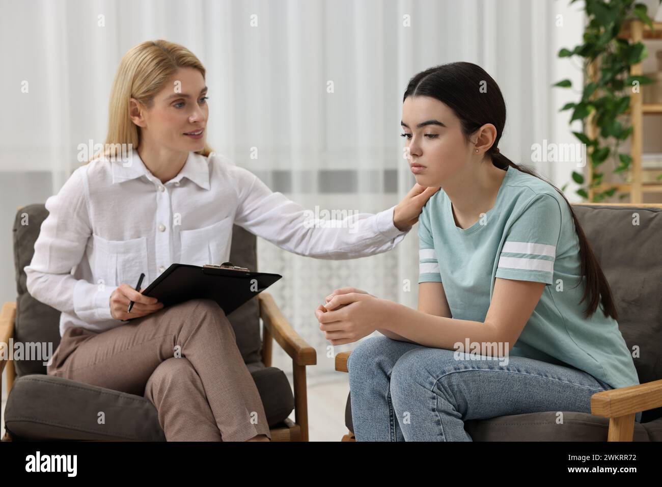 Psychologist working with teenage girl in office Stock Photo - Alamy