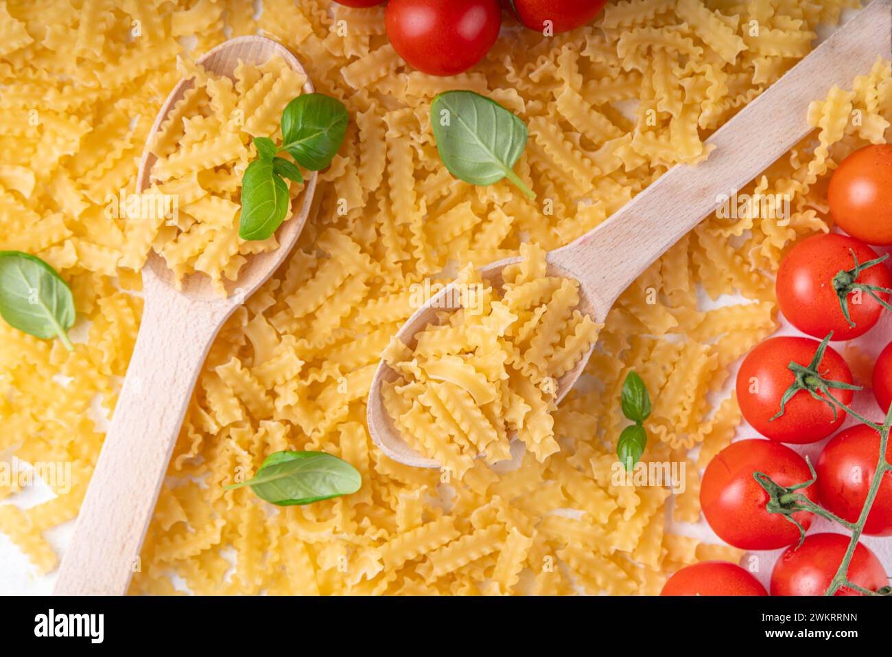 Raw uncooked Mafaldine pasta with ingredients for cooking. Short ...