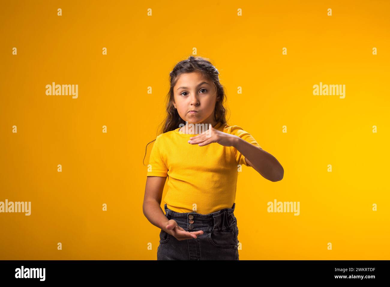 Portrait of girl showing big and large size sign, measure symbol ...