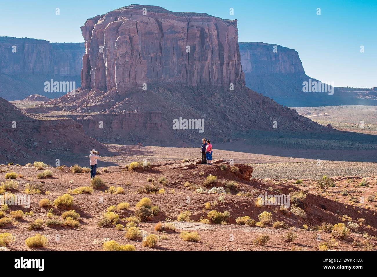 Tourists in Monument Valley, which is famous for its iconic buttes and ...