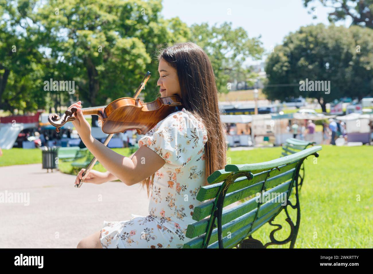 young latin woman venezuelan artist violinist busker in park in buenos ...