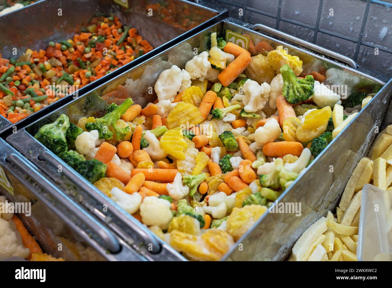 Frozen vegetables. Selling frozen vegetables in the fridge of a grocery ...
